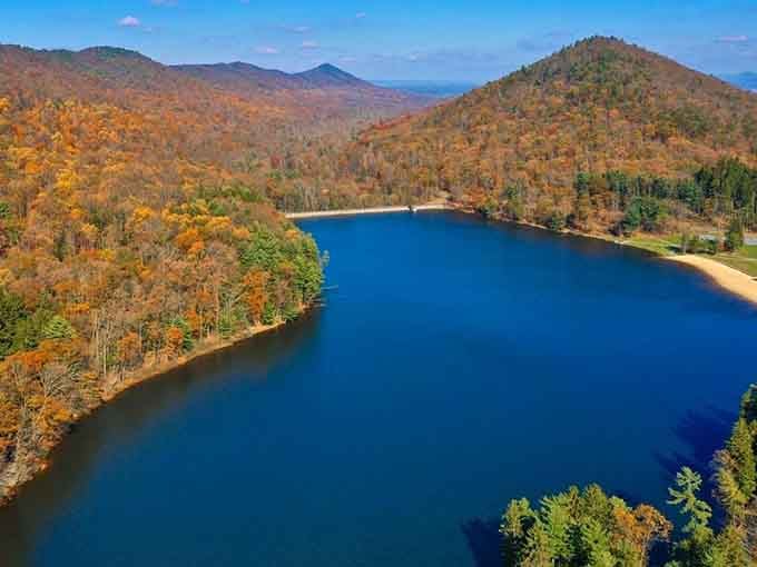 From this bird's-eye view, the lake nestled between autumn-painted mountains looks like nature's own jewel box.