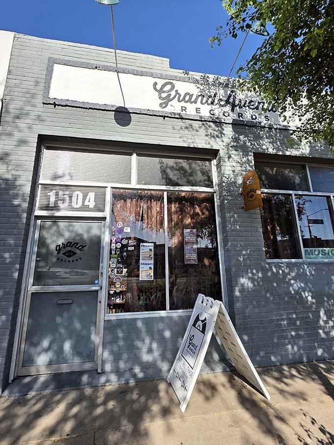Dappled sunlight on gray siding creates an artsy vibe perfect for the indie music treasures waiting inside.