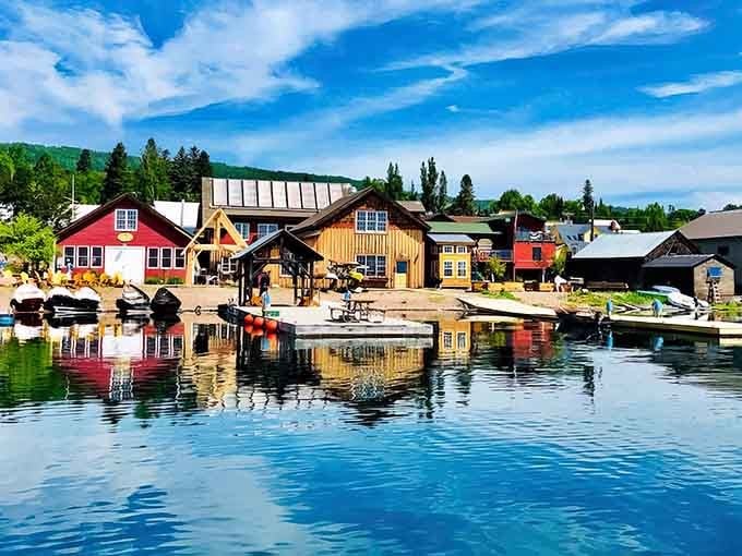 Colorful waterfront buildings reflect perfectly in the harbor like a Norwegian postcard come to vibrant life.