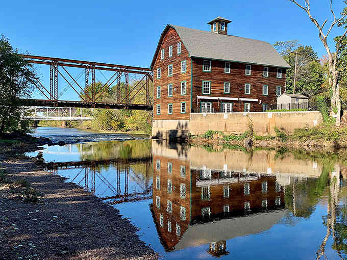 When a historic mill reflects in still water, you know you've found a place where time slows down deliciously.