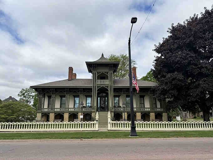 Victorian elegance meets tropical dreams in this ornate mansion that looks wonderfully lost on its Michigan street.