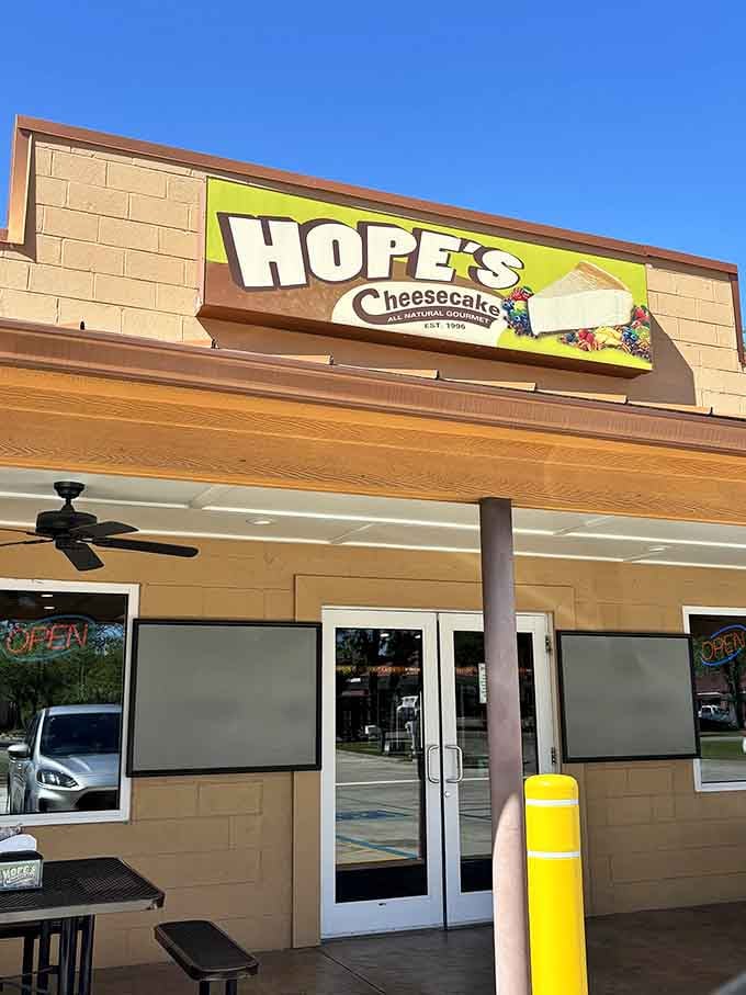 That bright lime-green sign practically shouts "cheesecake paradise" to anyone driving by looking for creamy perfection.