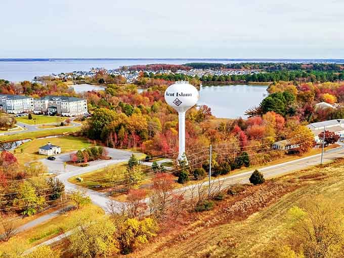 Kent Island's autumn foliage blazes with color, painting the landscape in reds and golds around the water tower.