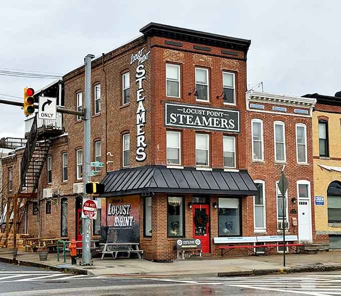 This classic brick corner building wears its heritage proudly with bold vertical signage reaching toward the sky.