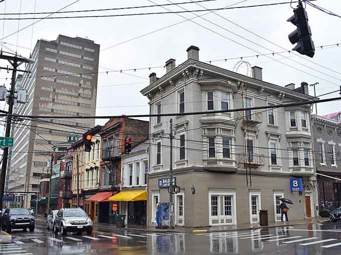 Rain-slicked streets reflect old buildings, creating a moody scene that Edward Hopper would've loved to paint.
