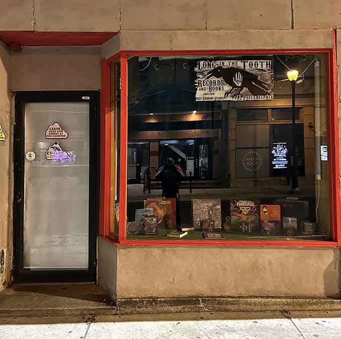 That red-trimmed window showcases carefully curated albums like precious artifacts from rock and roll history.