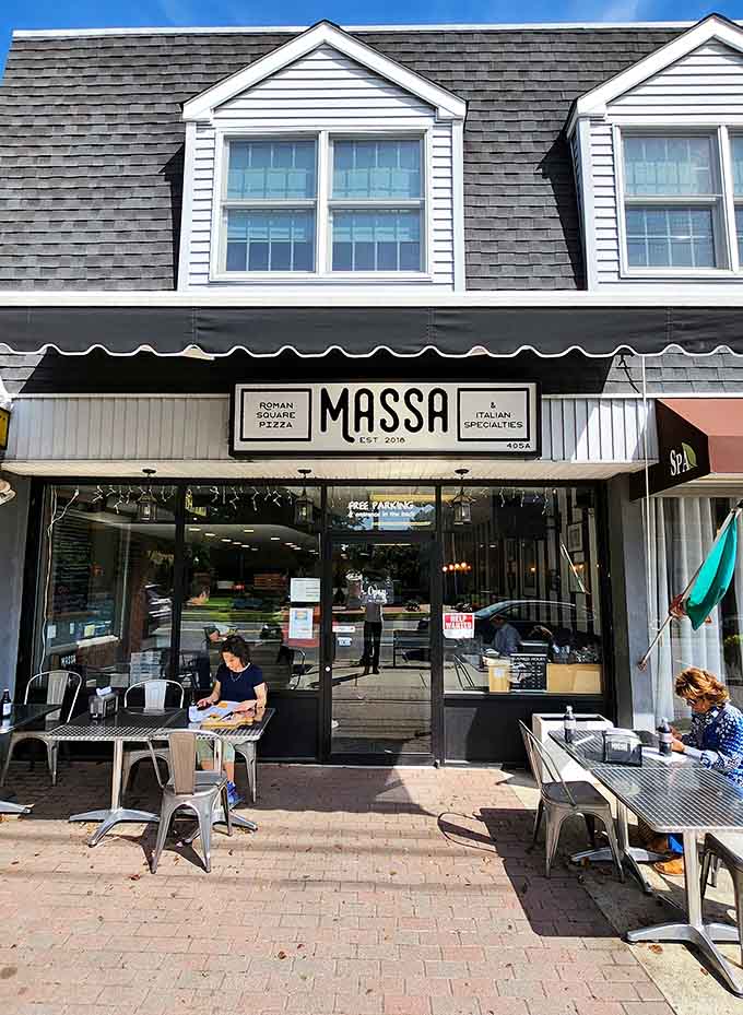 Roman square pizza gets the spotlight it deserves beneath this clean, contemporary awning that screams sophisticated simplicity.