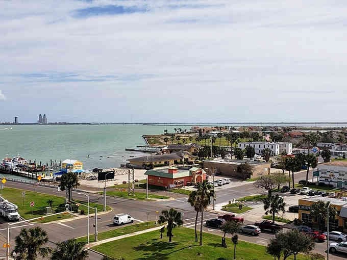 Palm trees swaying over coastal waters where fishing boats and fresh seafood are the daily routine.