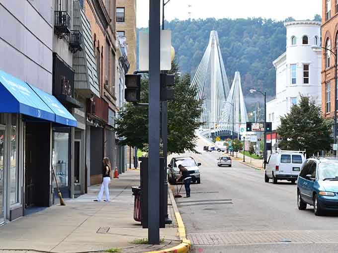 That modern bridge gleams in the distance, connecting past and present in one spectacular architectural handshake across the river.