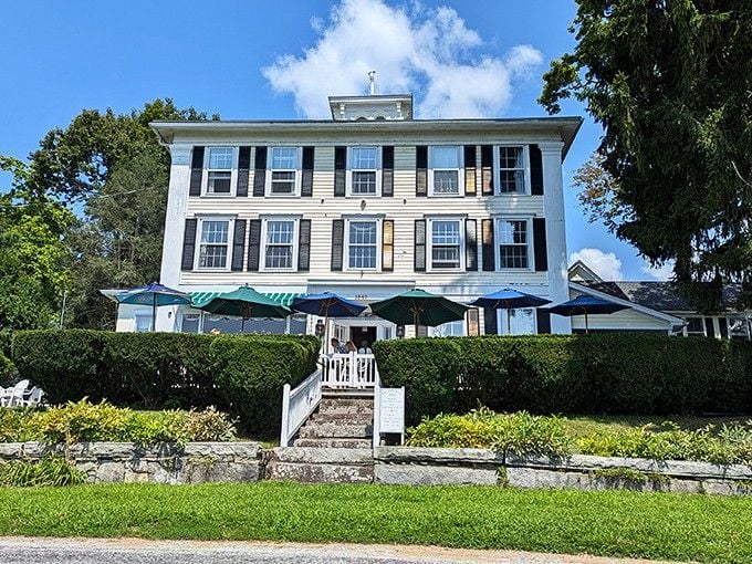 This stately white building with black shutters overlooks the lake like a gracious host welcoming old friends.