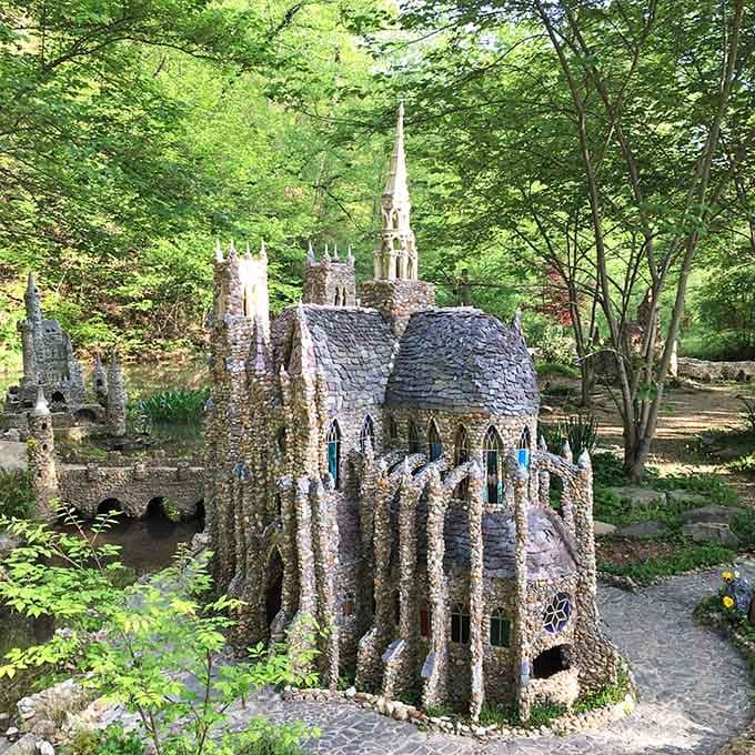 This miniature stone church rises from the garden like something Gulliver might have stumbled upon during his travels.