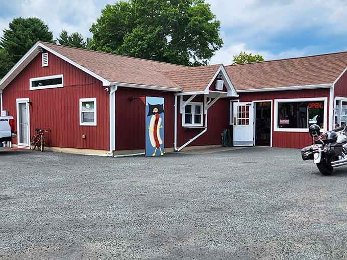 Tom's rustic red barn exterior with motorcycles parked outside attracts riders who know where quality hot dogs hide.