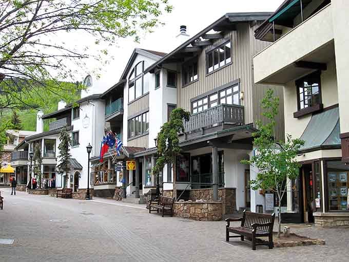 Alpine-style buildings line pedestrian streets where European charm meets Rocky Mountain grandeur in delightful harmony throughout.