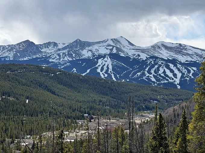 Snow-capped peaks tower over Breckenridge's ski runs, reminding you that summer's green eventually surrenders to winter's white magic.