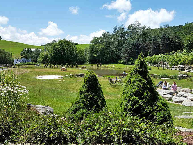Rolling green hills cradle this peaceful landscape where nature does the decorating better than any designer could.