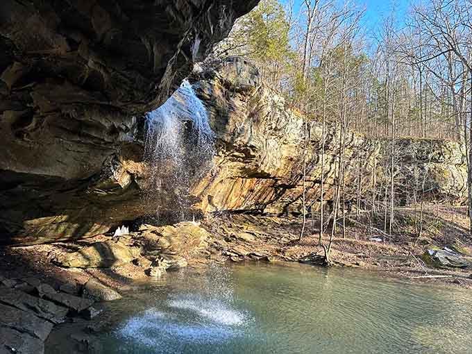 The rocky overhang creates a natural amphitheater where water performs its eternal symphony for lucky visitors below.