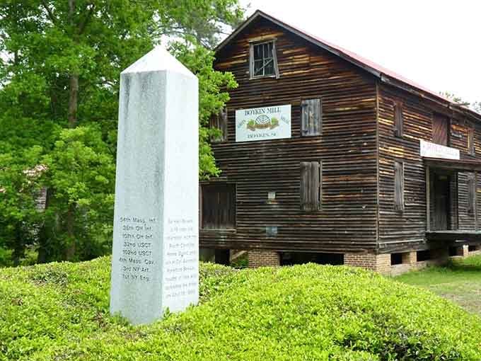 The historic mill stands weathered but proud, its wooden walls holding stories of generations who worked these very floors.