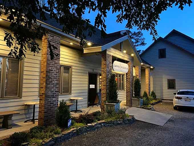 Evening lights illuminate Caffe Piccolo's charming facade where authentic Italian flavors meet Southern hospitality in the most delightful way.