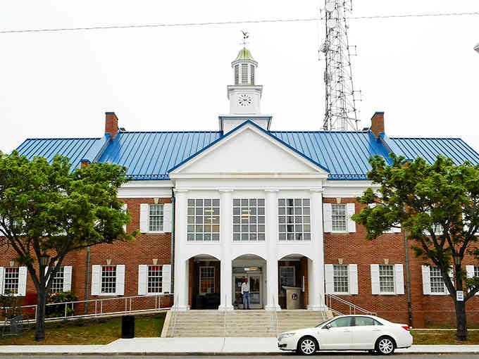 That distinctive blue roof catches your eye immediately, marking the civic heart of this welcoming coastal community.