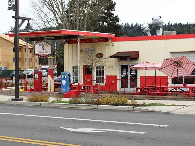 Vintage gas pumps painted bright red add nostalgic charm to this cheerful gathering spot that celebrates simpler times beautifully.