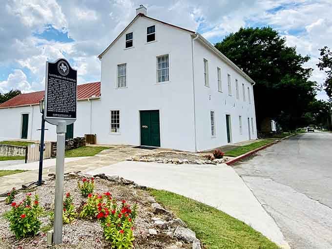 This pristine white structure with its historical marker proves that sometimes the simplest buildings tell the most fascinating stories.