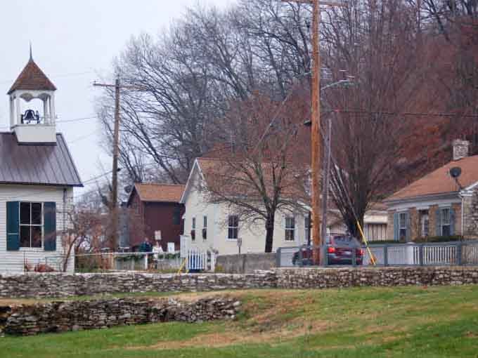 Stone walls and bare trees frame a village that's weathered every season with quiet dignity and unwavering grace.