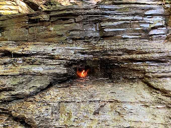 Look closer at the layered rock to spot that eternal glow burning steadily in its hidden grotto.