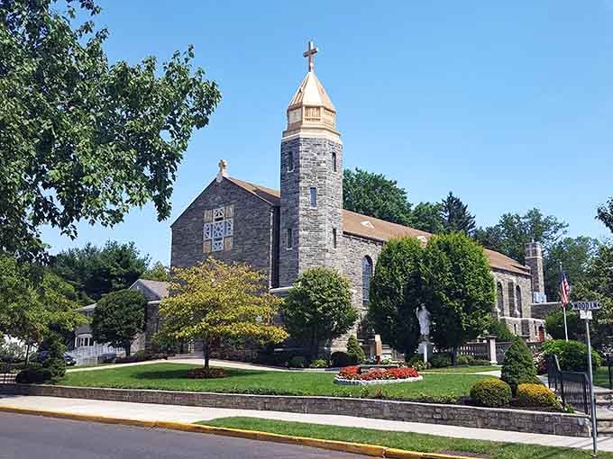 Stone church architecture surrounded by manicured gardens creates a scene of quiet dignity and enduring community spirit.