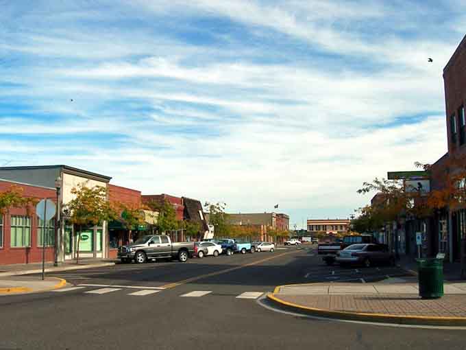 Wide streets and brick storefronts whisper small-town charm, where parking is easy and neighbors still wave to strangers.