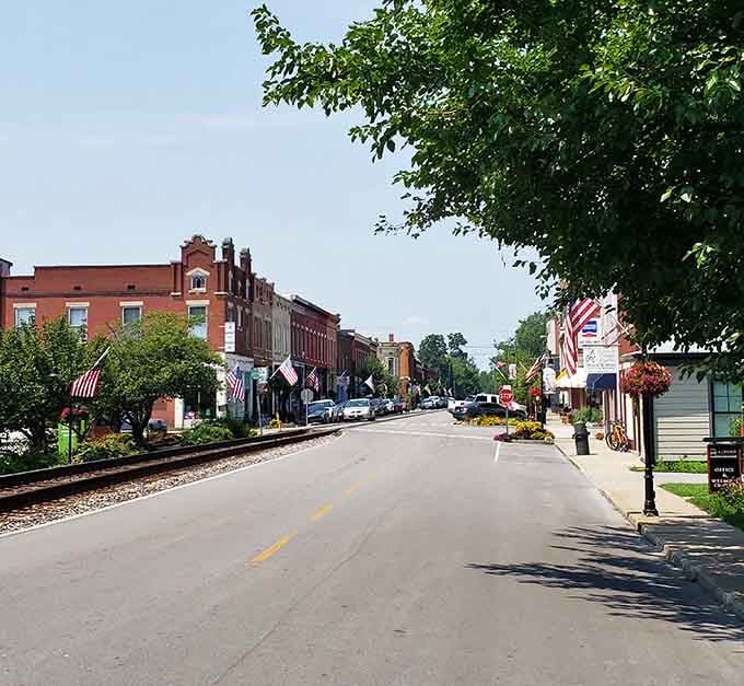 Flags wave proudly along streets where history and modern life shake hands and agree to coexist beautifully together.