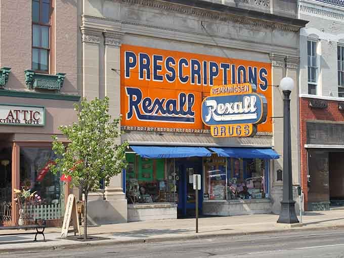 That bold Rexall sign pops like a beacon from simpler times when the corner drugstore anchored every community.