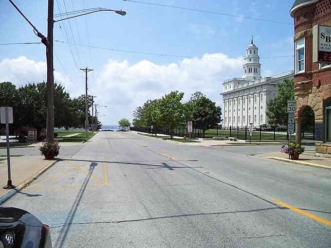This peaceful street view shows how the temple anchors the entire town, visible from blocks away like a lighthouse.