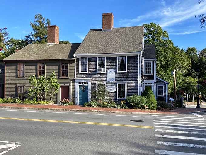 Weathered shingles and white trim tell centuries of stories in this perfectly preserved colonial building standing proud.
