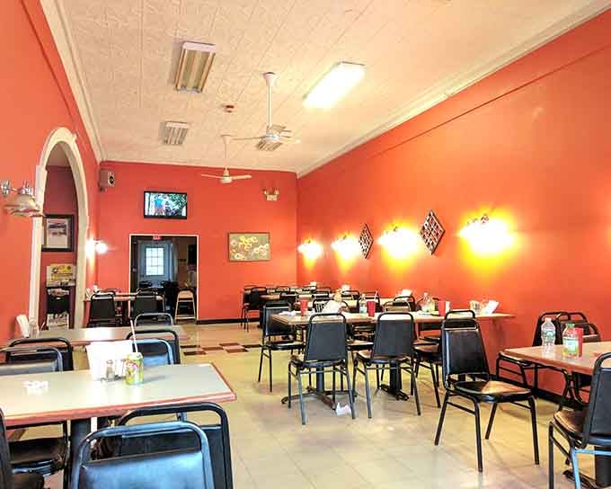 Those vibrant orange walls and arched doorways create a cheerful, unpretentious space where locals gather for satisfying meals and good company.
