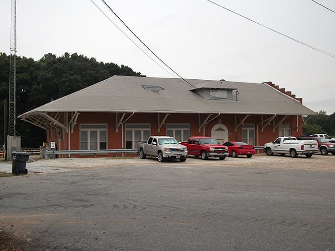The old train depot's wide roof sheltered countless arrivals back when railroads connected every dream.