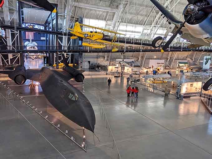 Inside this massive hangar, aircraft hang suspended like frozen dreams, from spy planes to spacecraft that actually touched the stars.