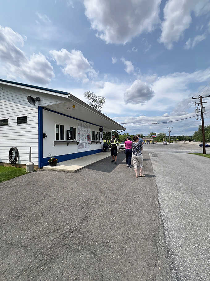 Under dramatic clouds, families gather at this countryside stand where soft serve dreams come true daily.