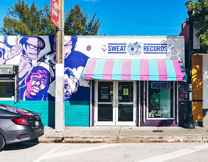 The candy-striped awning and neon "OPEN" sign promise sweet discoveries inside for every serious collector who enters.