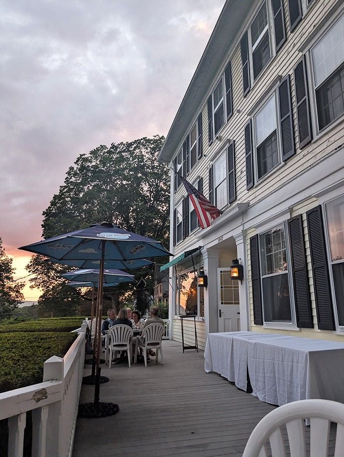 Sunset paints the sky cotton candy pink while diners savor the view from this elegant lakeside terrace.