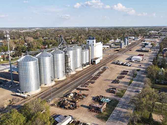 Those grain elevators rise like silver monuments to the hardworking agricultural heritage feeding our nation.