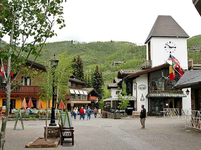 The village clock tower stands proud while mountain meadows roll upward, creating scenes straight from Sound of Music.