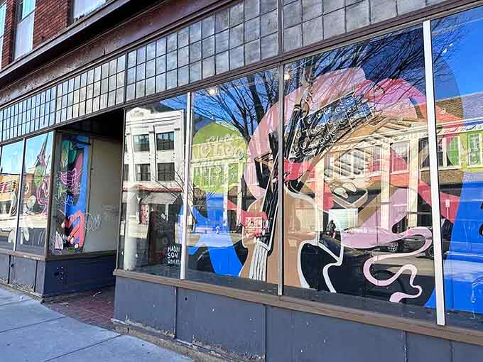 The artistic window murals turn this storefront into a celebration of music culture and creative expression.