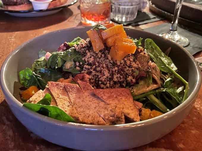 Fresh greens meet roasted vegetables in a bowl that proves healthy eating doesn't require sacrificing flavor or fun.
