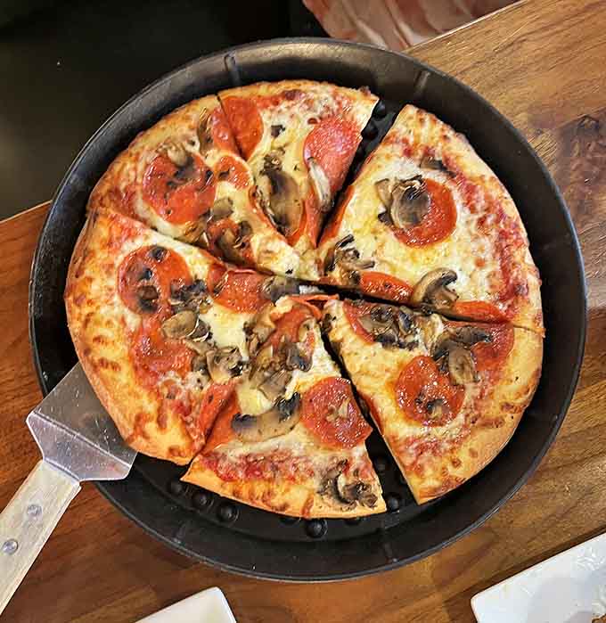 Pepperoni and mushrooms team up on thin crust for a classic combination that never disappoints anyone.