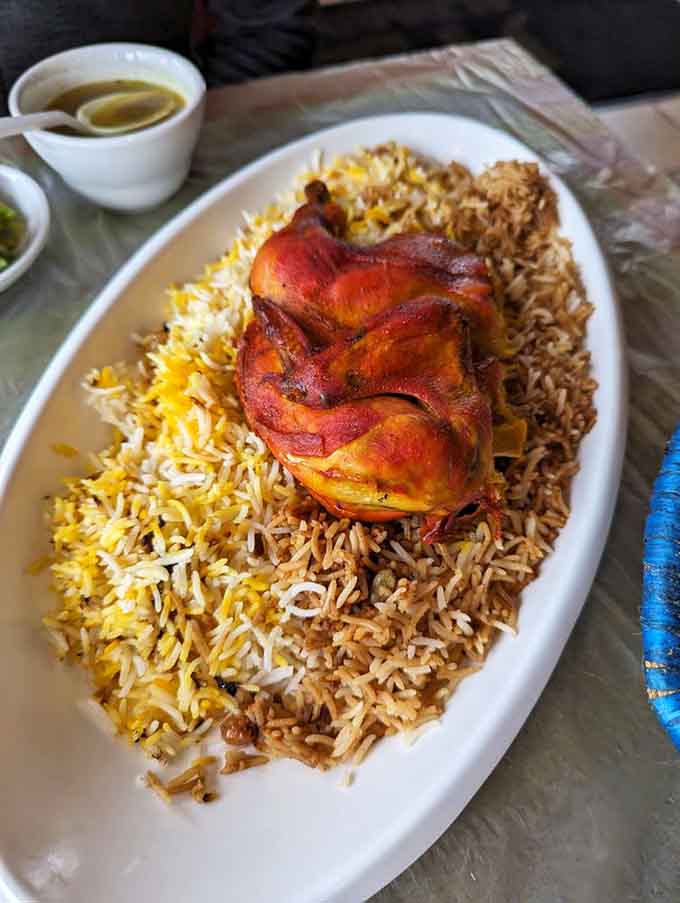 Golden chicken perched atop fragrant rice like it's posing for its own cooking show debut episode.
