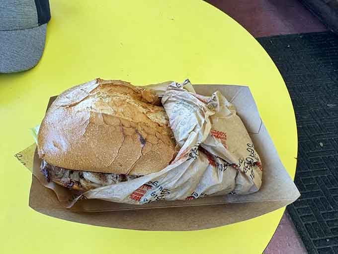 The steak sandwich arrives wrapped like a precious gift, which is exactly what it is.