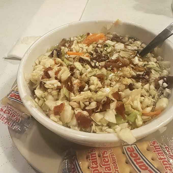 Hot bacon slaw might sound unusual, but one bite explains why locals have been ordering it for generations.