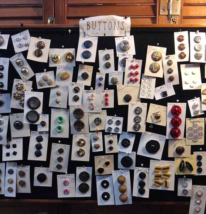 Buttons organized with more care than most people give their retirement planning, each one a tiny work of art.