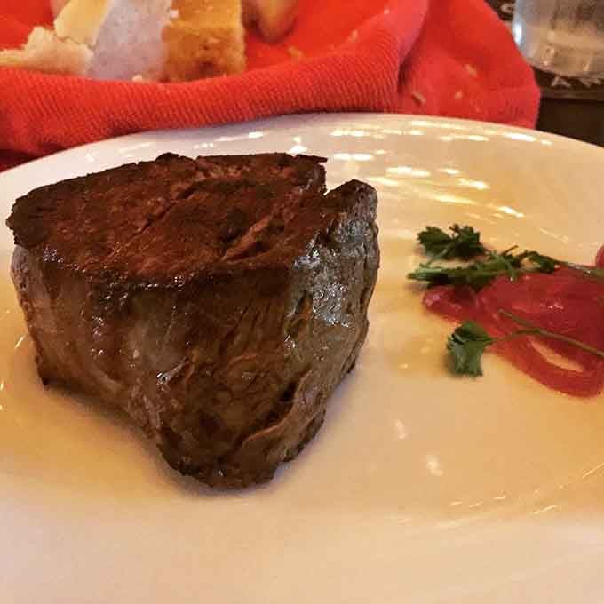 This filet mignon is so tender it practically melts on your fork, the kind of steak dreams are made of.