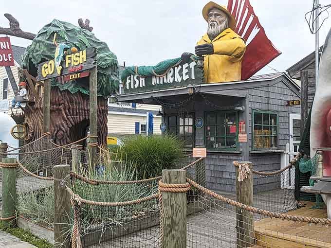 That giant fisherman statue has seen more summer memories than your entire photo album combined, guaranteed.